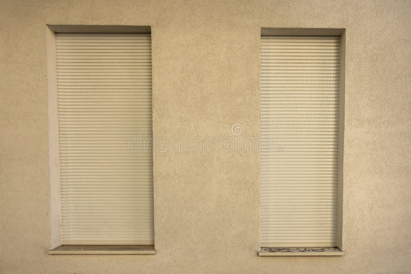 Two Windows with Closed Shutters on a Simple House Facade. Stock Image ...