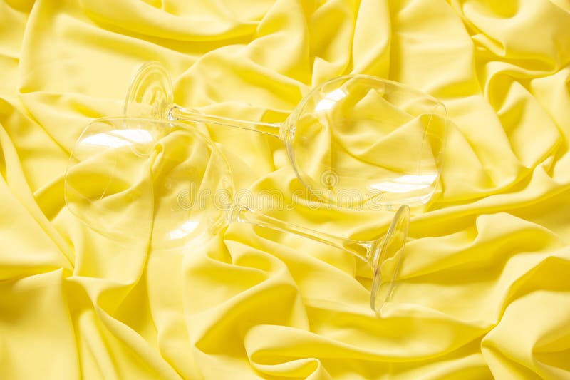 Two Wine Glasses Lie on a Yellow Cloth, a Wine Glass Stock Photo ...