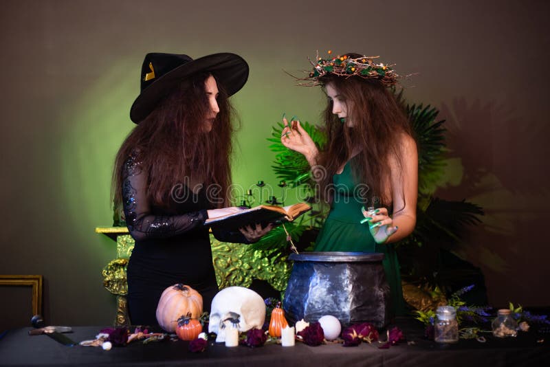 Two Witches with a Book with a Pentagram Stand at a Table with a ...