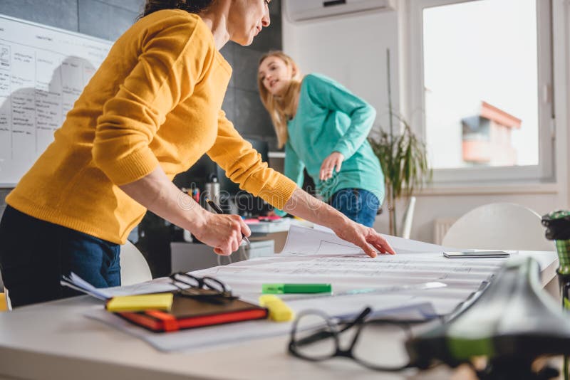 Two Woman Checking Blueprints Stock Photo - Image of businesswoman ...