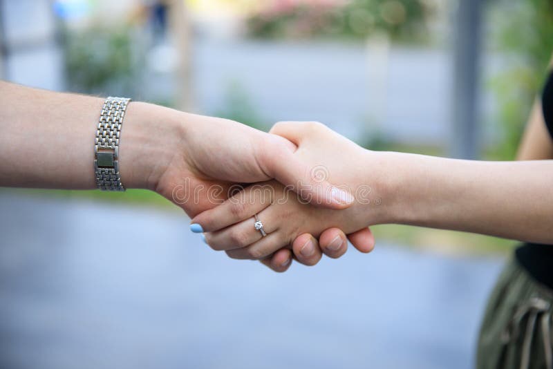 Two woman greet by hand stock photo. Image of teens - 189472444
