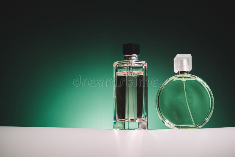 Woman Perfume Bottles on Green Background. Choice Perfume Stock Photo ...