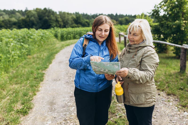 Two Womans in Active Trekking Clothes with Map Having a Halt after ...