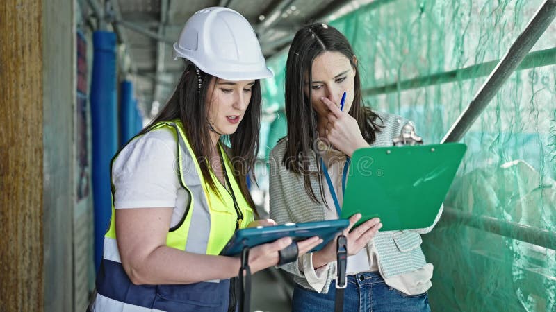 Two Women Architect and Worker Using Touchpad and Clipboard Working at ...