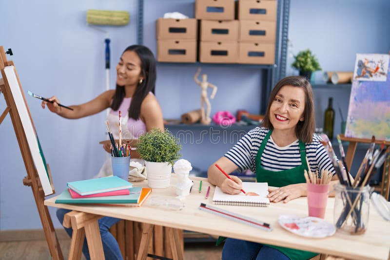 Two Women Artists Drawing on Canvas and Notebook at Art Studio Stock ...