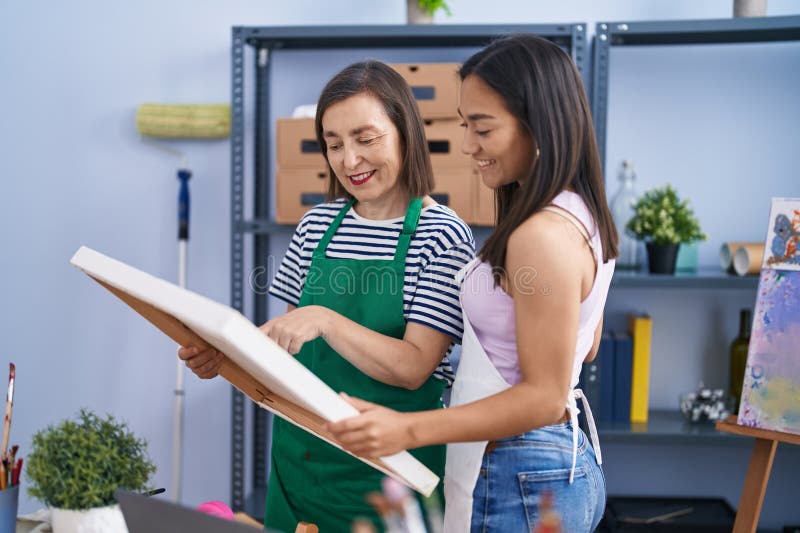 Two Women Artists Standing Together Looking Draw at Art Studio Stock ...