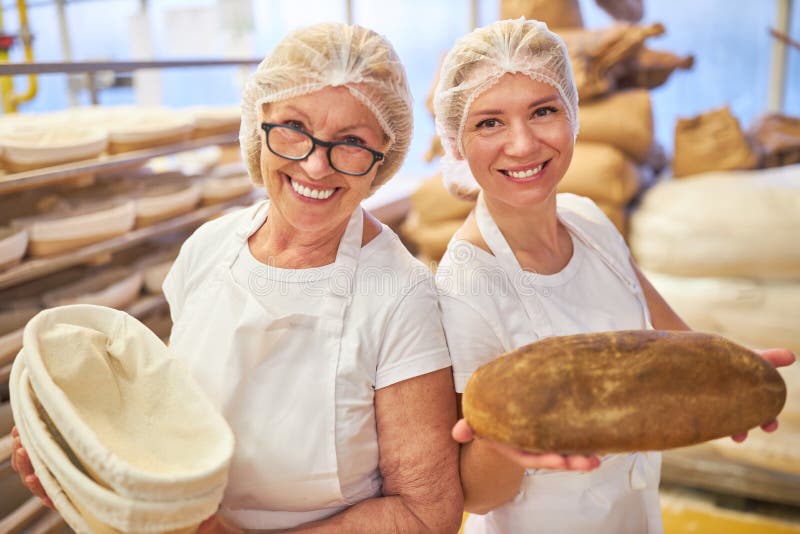 Two Women in the Bakery Team with Bread Baskets and Bread Stock Photo ...