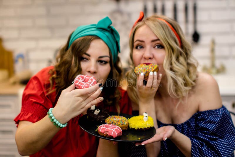Two Women Bite Tasty Donuts during a Diet. Stock Photo - Image of ...
