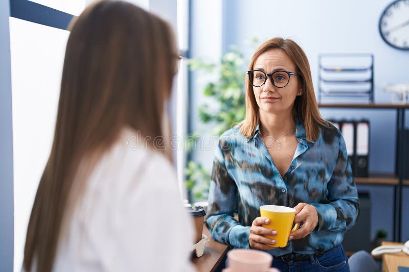 Two Women Business Workers Drinking Coffee Speaking at Office Stock ...