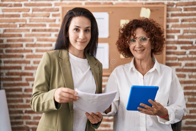 Two Women Business Workers Reading Document Using Touchpad at Office ...