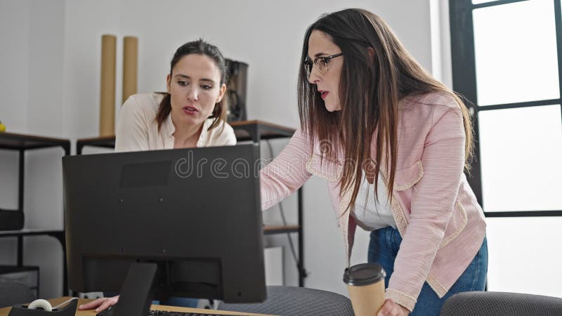 Two Women Business Workers Using Computer Drinking Coffee at Clinic ...