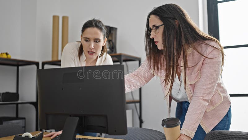 Two Women Business Workers Using Computer Drinking Coffee at Office ...
