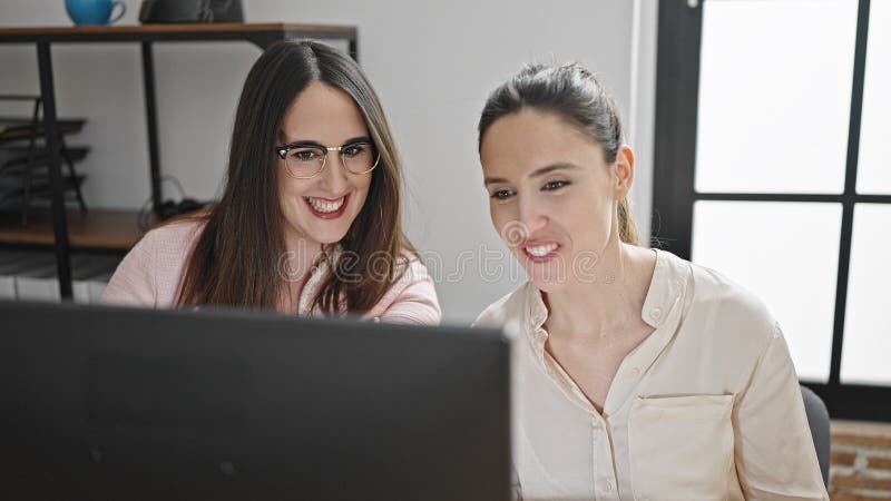 Two Women Business Workers Using Computer Speaking at Office Stock ...