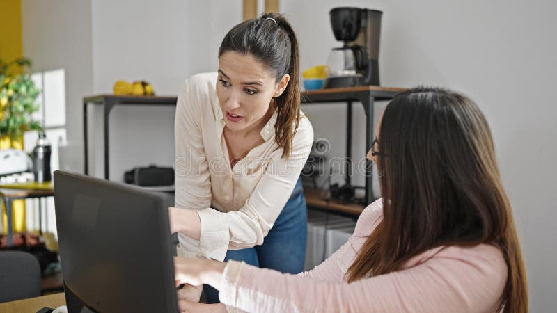 Two Women Business Workers Using Computer Speaking at Office Stock ...