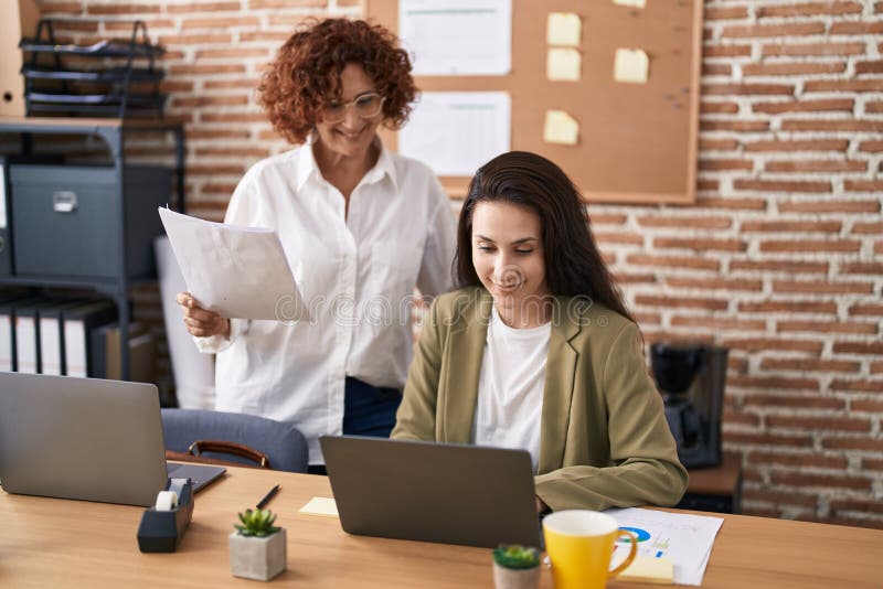 Two Women Business Workers Using Laptop Reading Document at Office ...