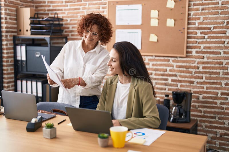 Two Women Business Workers Using Laptop Reading Document at Office ...