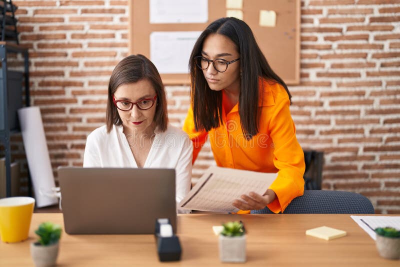 Two Women Business Workers Using Laptop Reading Document at Office ...