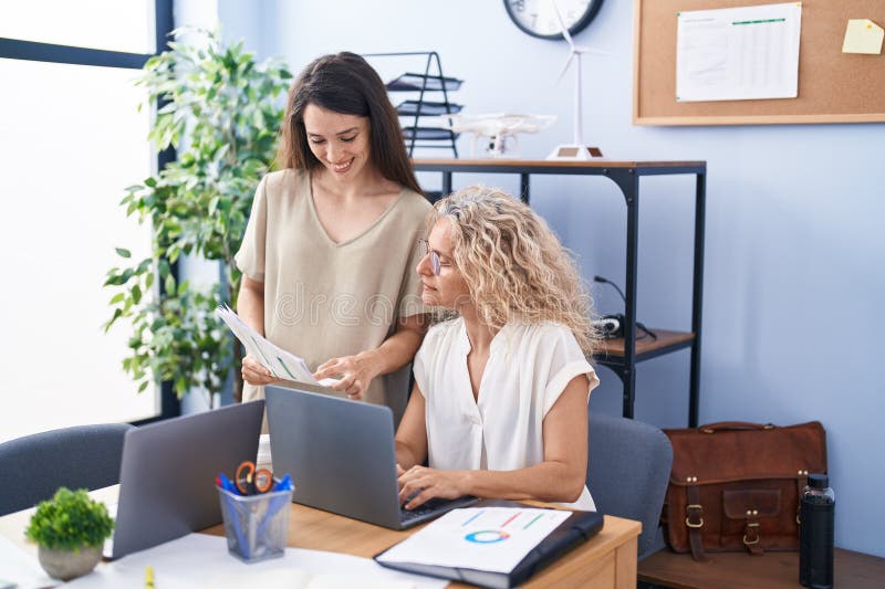 Two Women Business Workers Using Laptop Reading Document at Office ...