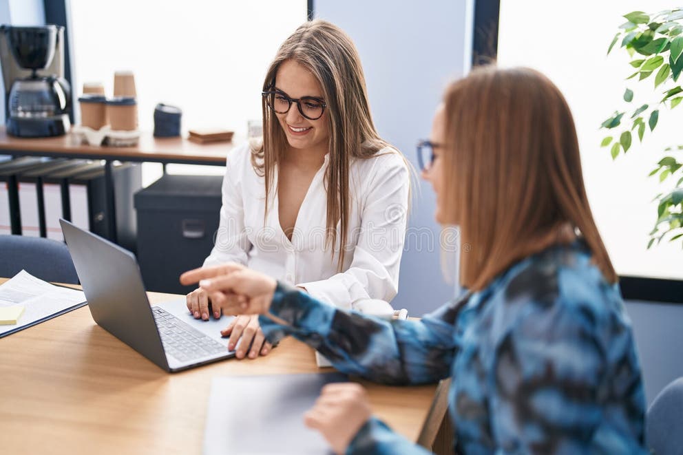 Two Women Business Workers Using Laptop Speaking at Office Stock Photo ...