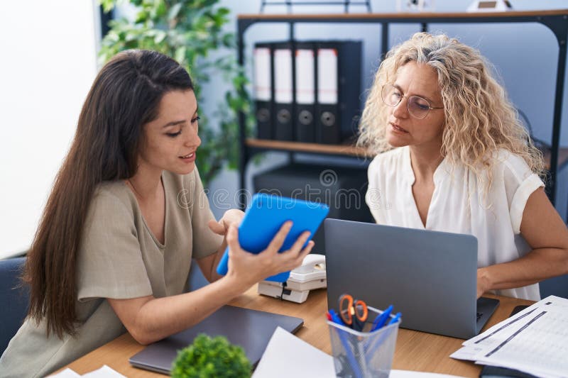 Two Women Business Workers Using Laptop and Touchpad at Office Stock ...