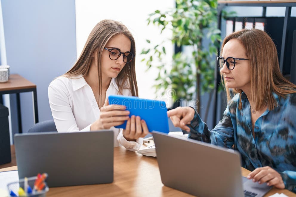 Two Women Business Workers Using Laptop and Touchpad Working at Office ...