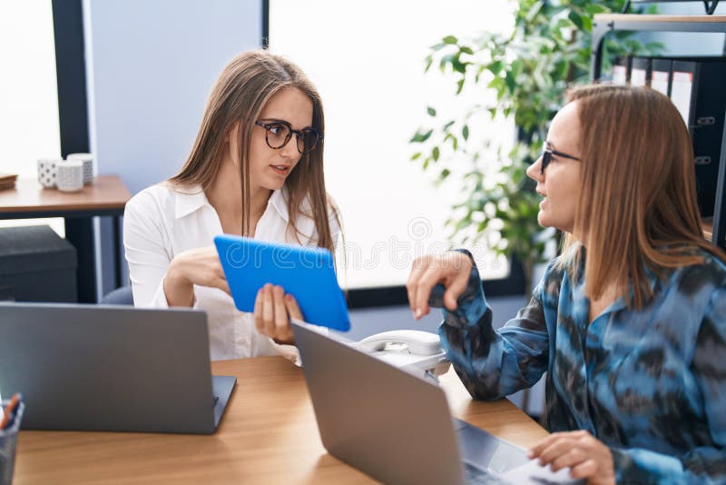 Two Women Business Workers Using Laptop and Touchpad Working at Office ...