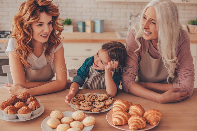 Two Women and Child with Baking Products on the Table Laughing at the ...
