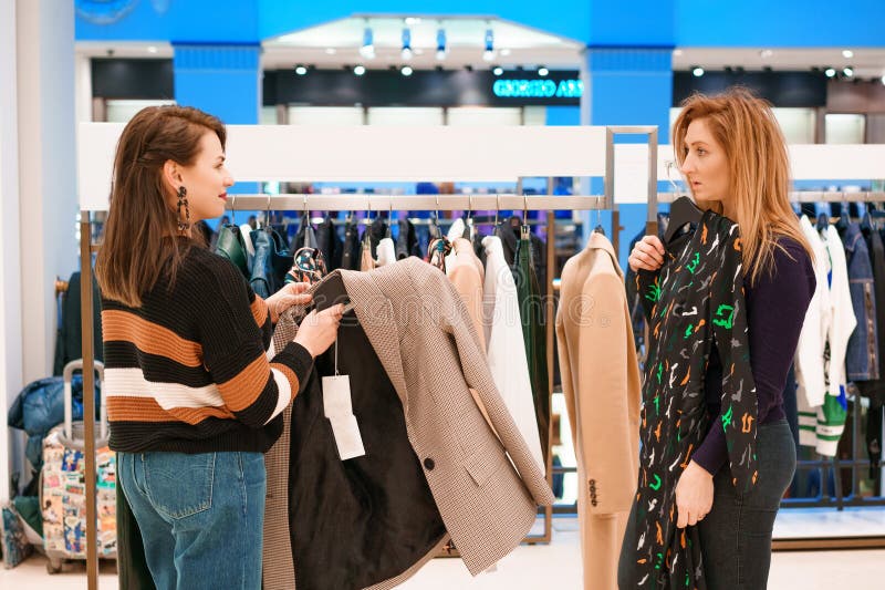 Two Women Choose Clothes In A Store Stock Photo - Image of apparel ...
