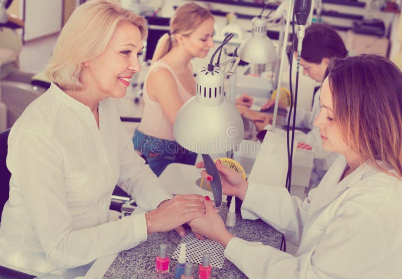 Two Women Clients Having Manicure Done in Nail Salon Stock Image ...