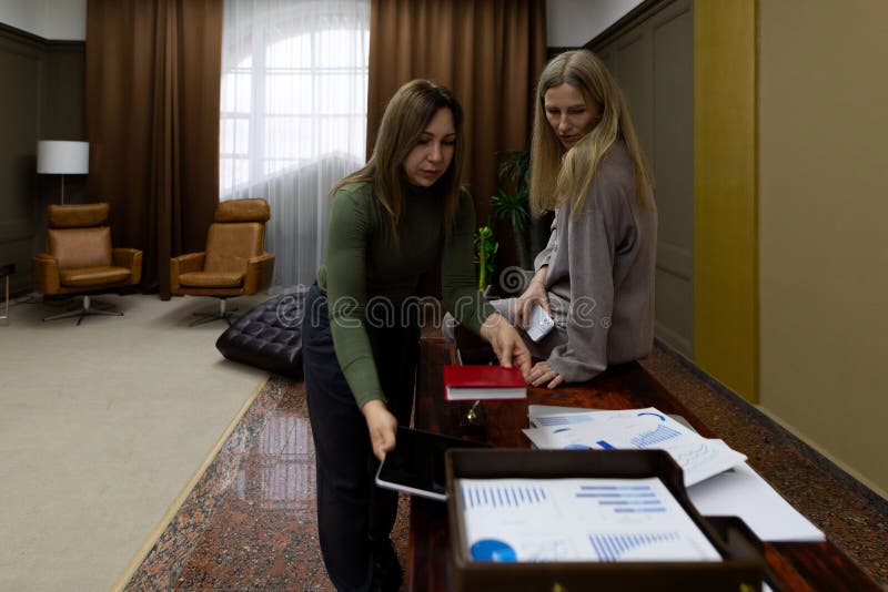 Two Women Collaborating on a Business Project in an Office Setting ...