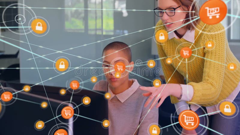 Two Women Collaborating at Computer in Tech Office, Showing Shopping ...