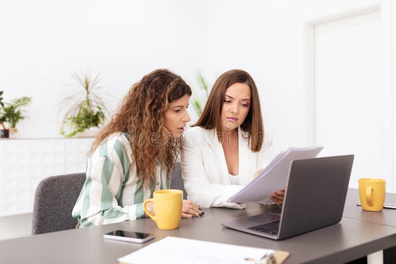 Two Women Collaborating on a Project in a Corporate Office Environment ...