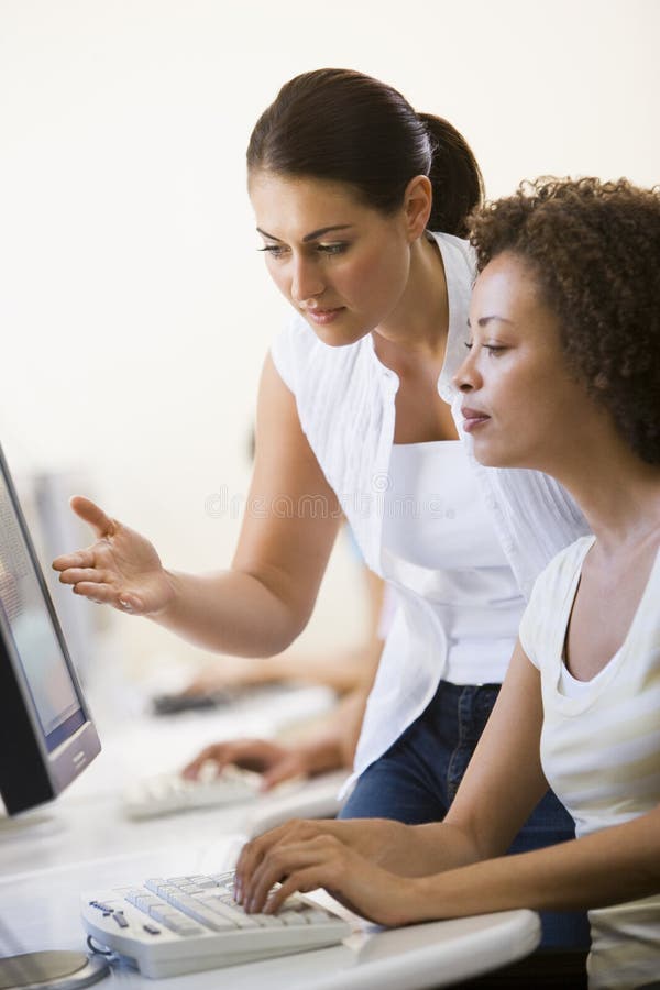 Two women in computer room stock photo. Image of staff - 5867540