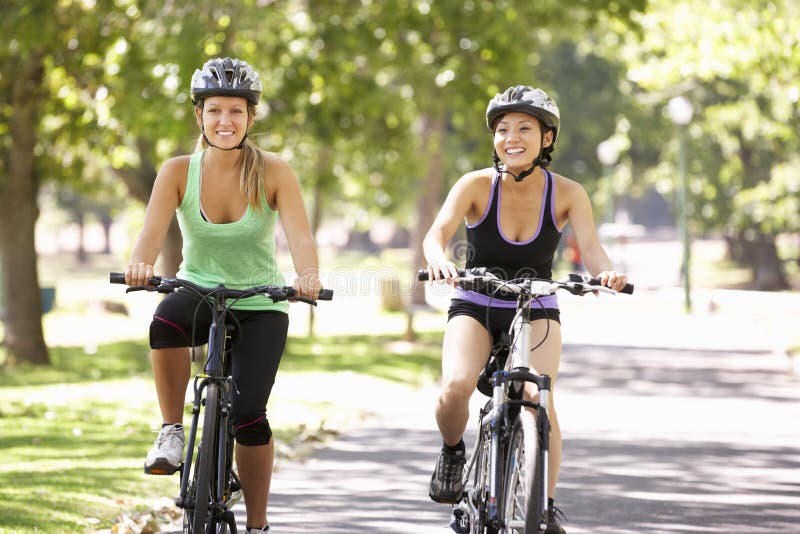 Two Women Cycling through Park Stock Image - Image of riding, healthy ...