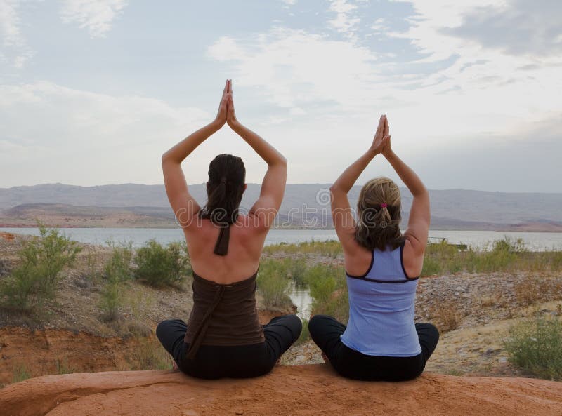 Two Women Doing Yoga at Sunset Stock Image - Image of adult, sunset ...