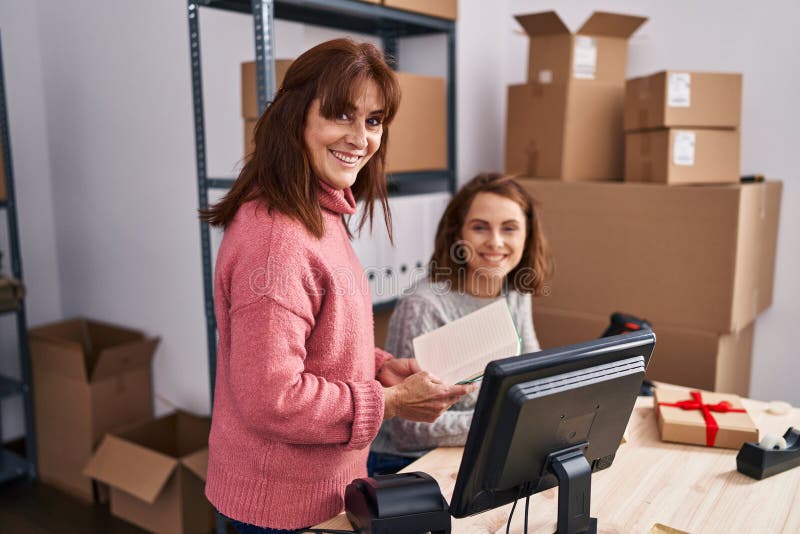 Two Women Ecommerce Business Workers Writing on Package Reading Book at ...