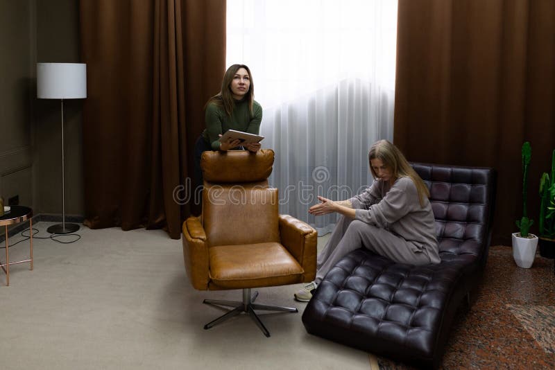 Two Women Engaging in a Discussion within a Stylish Interior Space ...