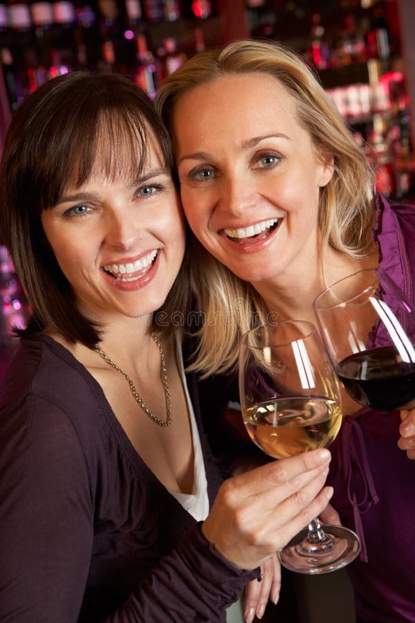 Two Women Enjoying Drink Together in Bar Stock Image - Image of night ...