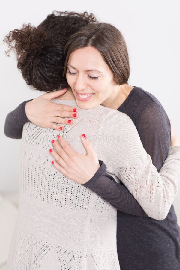 Two women giving a hug stock photo. Image of girlfriends - 54257702