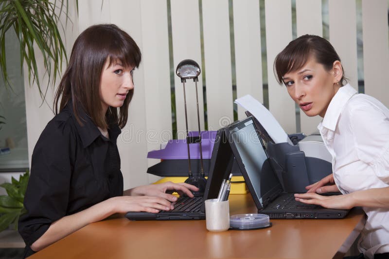Two women gossip in office stock photo. Image of business - 13917214