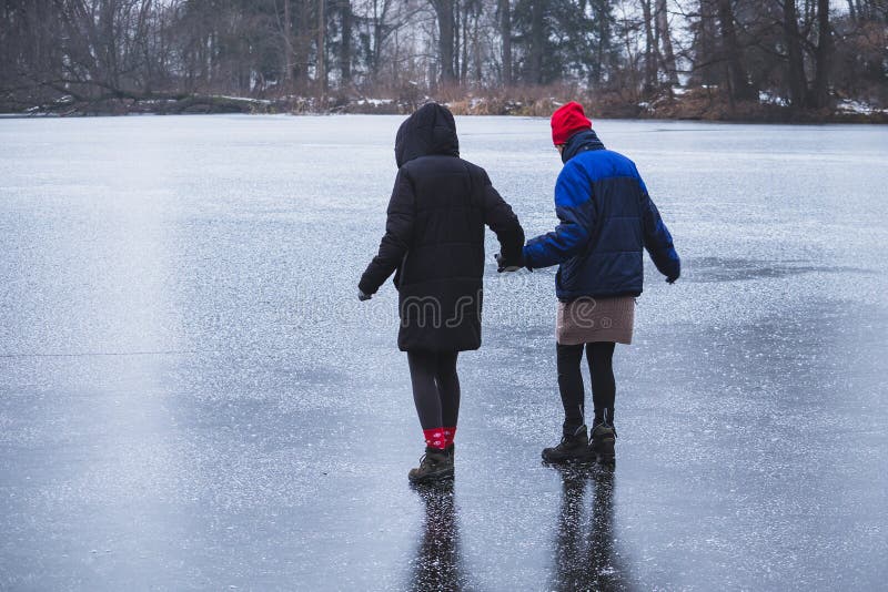 Two Women Holding Hands on the Ice Stock Image - Image of girls, people ...