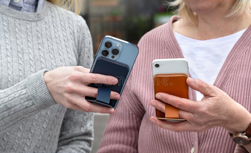 Two Women Holding Phones, Talking Stock Photo - Image of connection ...