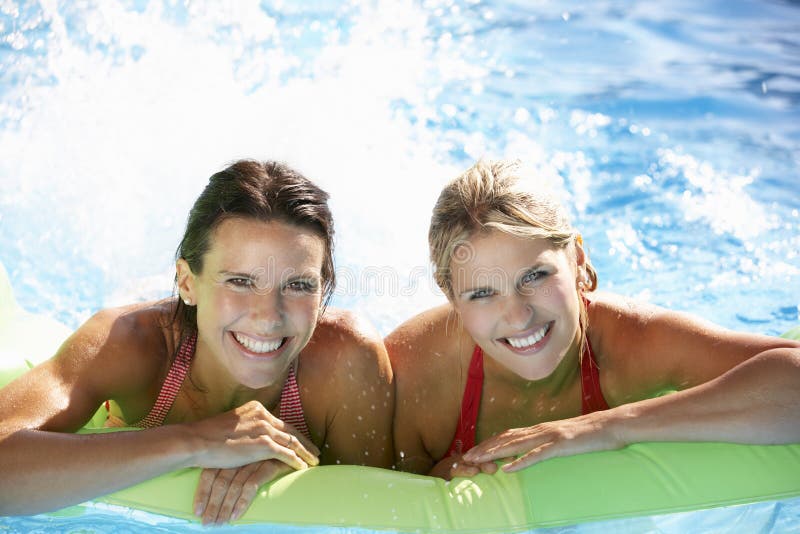 Two Women on Holiday in Swimming Pool Stock Photo - Image of swimsuit ...