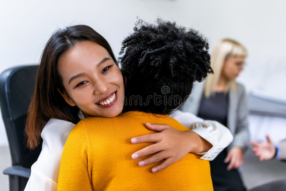 Business Women Hugging at a Group Therapy Session, Overcoming Problem ...