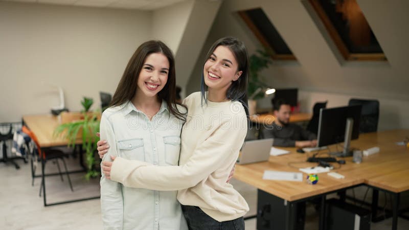 Two Women Hugging and Smiling at Each Other in Office Stock Footage ...