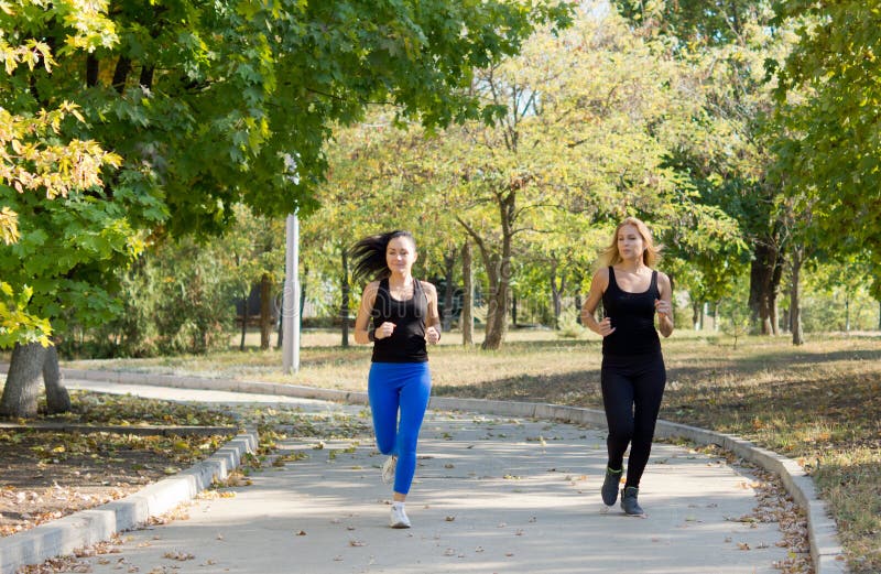 Two Women Jogging in a Park Stock Image - Image of working, outdoors ...