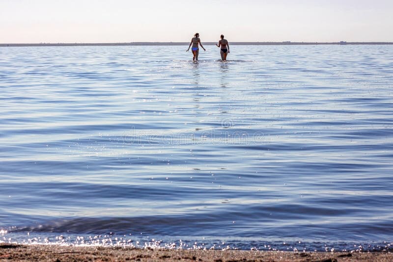 Two Women in Lake with Reflection Stock Image - Image of space ...