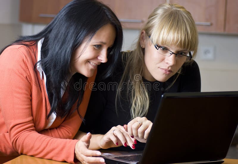 Two women on laptop stock image. Image of blonde, blond - 6571979