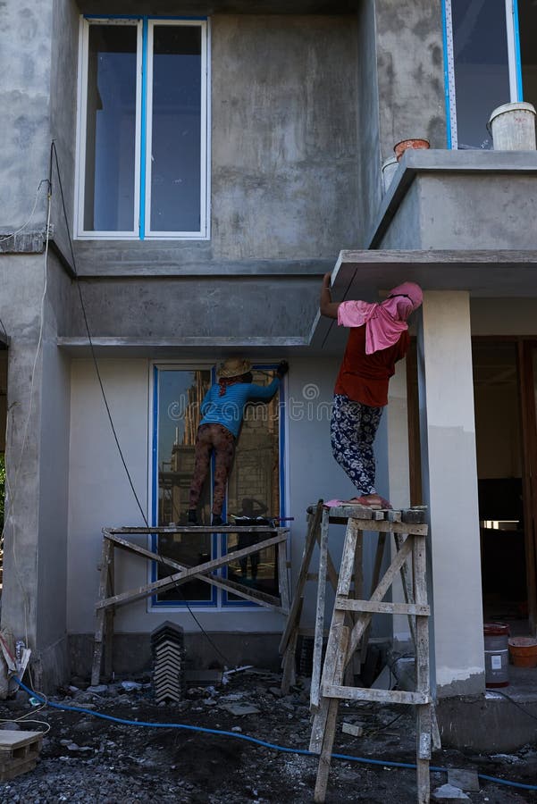 Two women make repairs stock photo. Image of rooftop - 201289366