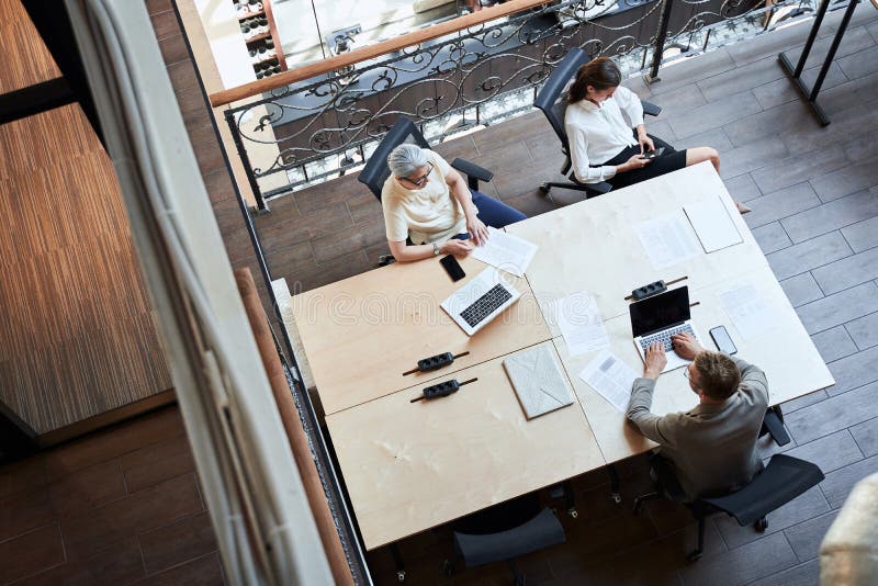 Two Women and a Man Sharing a Table at a Coworking Stock Image - Image ...
